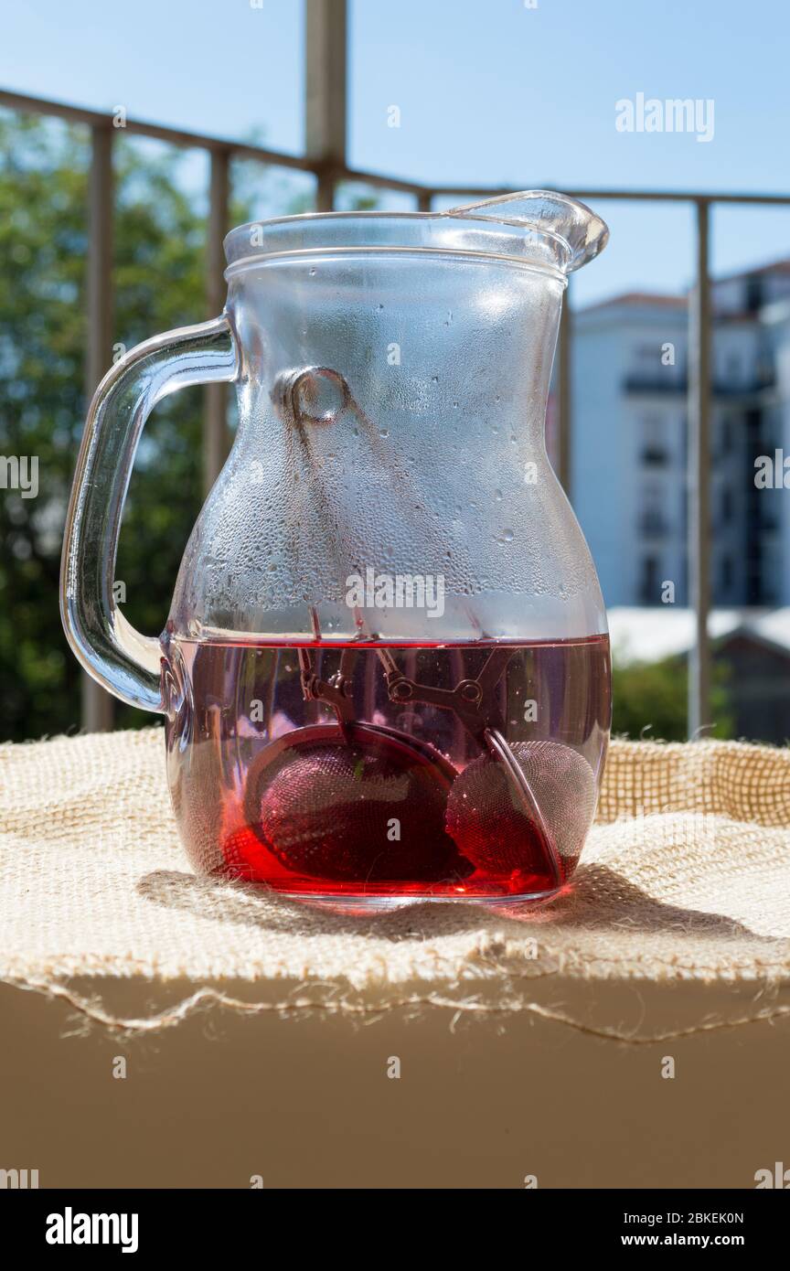 Red herbal infusion of hibiscus flowers on a terrace Stock Photo - Alamy