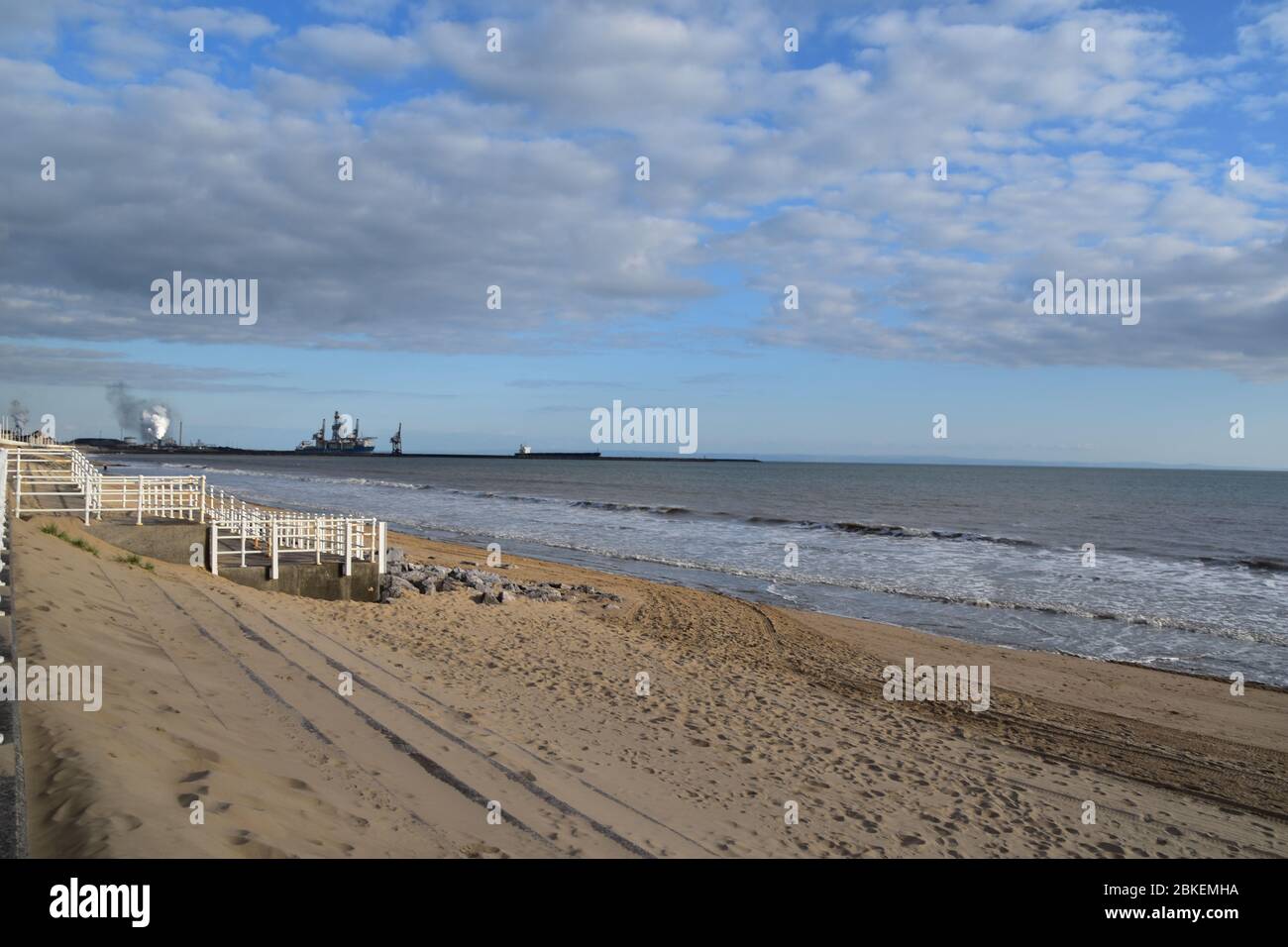 A landscape photograph of Port Talbot beach, with the steel works and ...