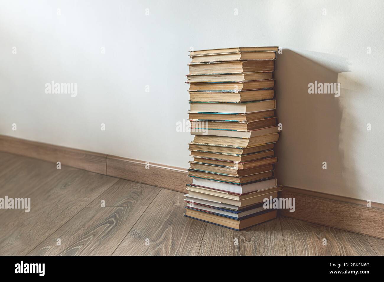 Big stack of old books over white wall, education concept, with copy ...