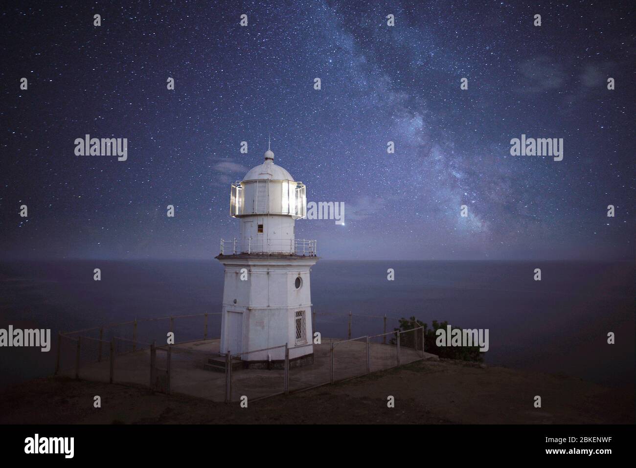 Lighthouse at night with starry sky and Milky Way Stock Photo - Alamy