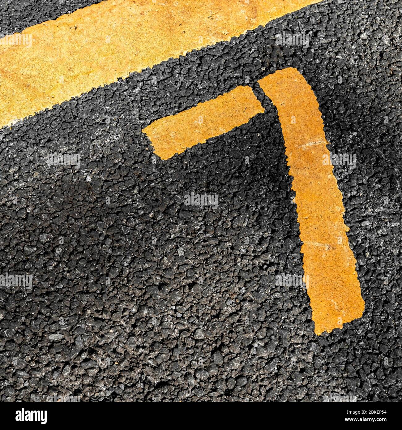 Asphalt parking lot with yellow lot line and yellow lot number 7, seven ...