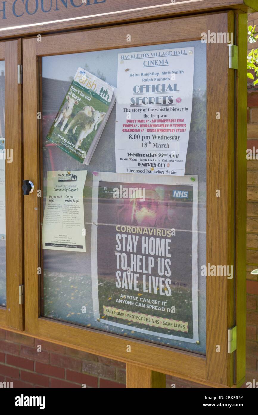 Glass fronted council notice board showing a Coronavirus warning poster ...