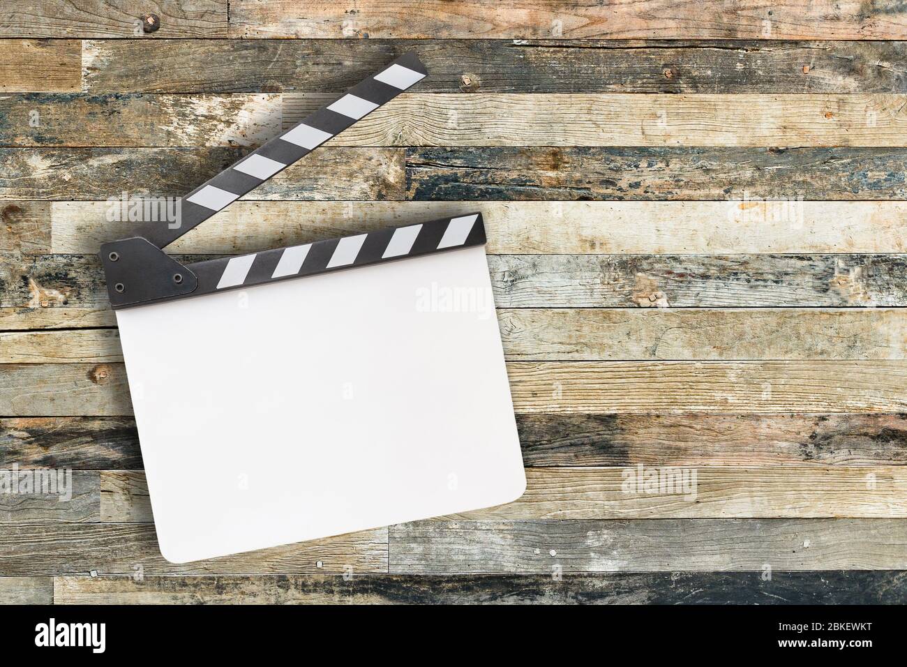 White movie clapper board on wooden background Stock Photo - Alamy