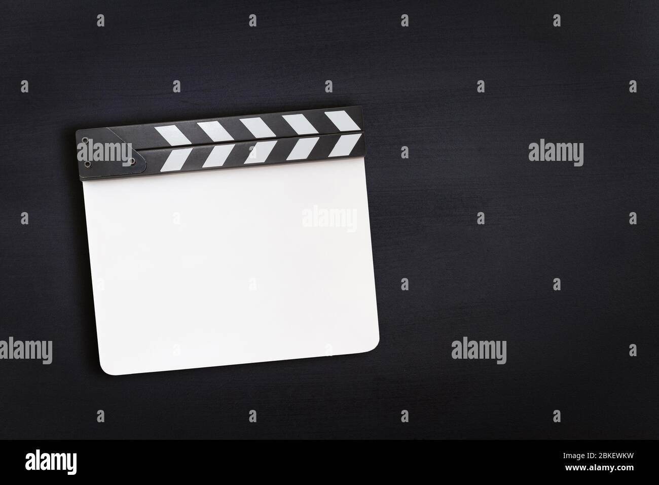 Closed blank clapper board on chalkboard background Stock Photo - Alamy