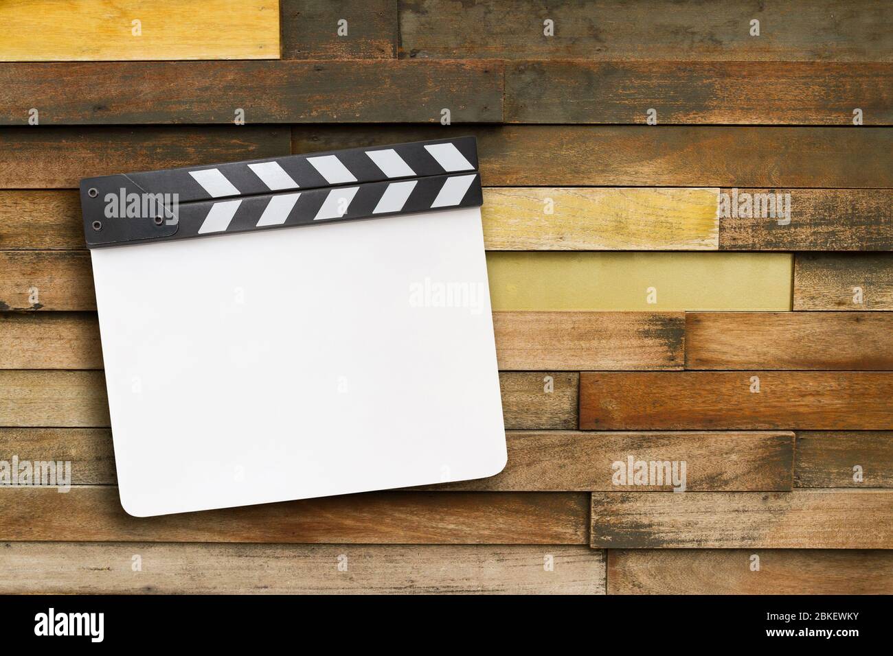 Closed blank white clapper board on wooden background Stock Photo - Alamy