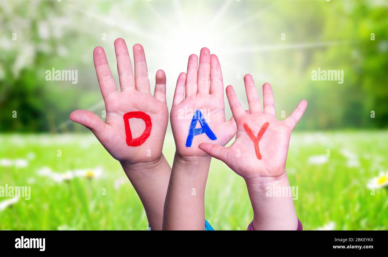 Children Hands Building Word Day, Grass Meadow Stock Photo - Alamy