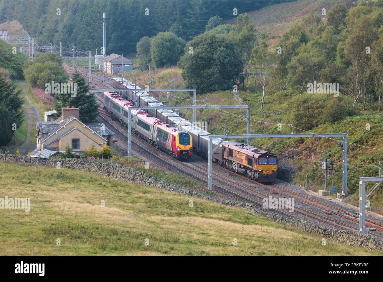 Virgin Trains class 221 voyager passing a DB Cargo class 66 hauling a ...