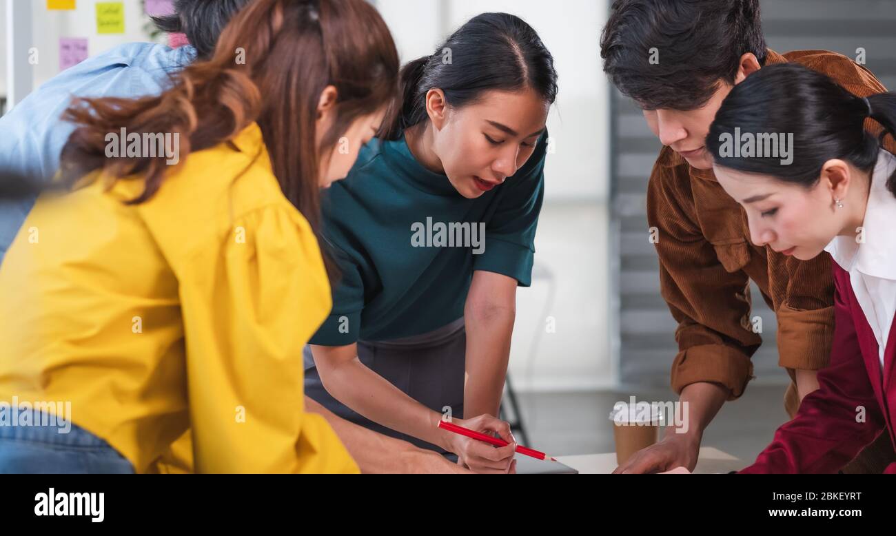 Asian Ux Developer And Ui Designer Brainstorming About Mobile App