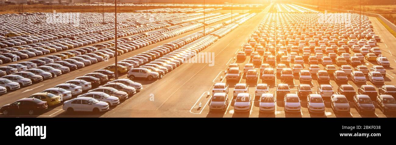 New cars parked in a distribution center on a sunset or sunrise and car ...