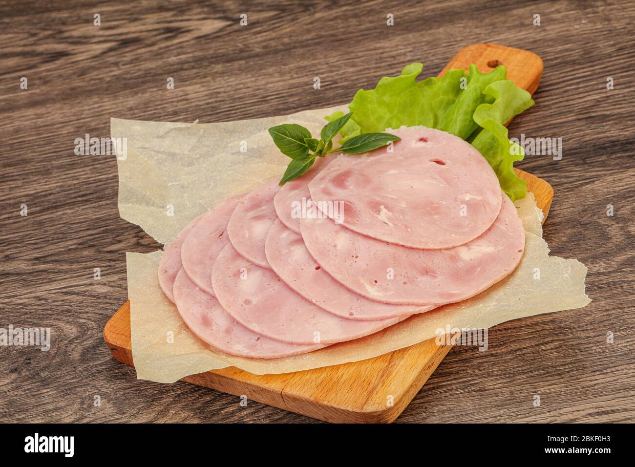 Slised ham pork snack over board Stock Photo - Alamy