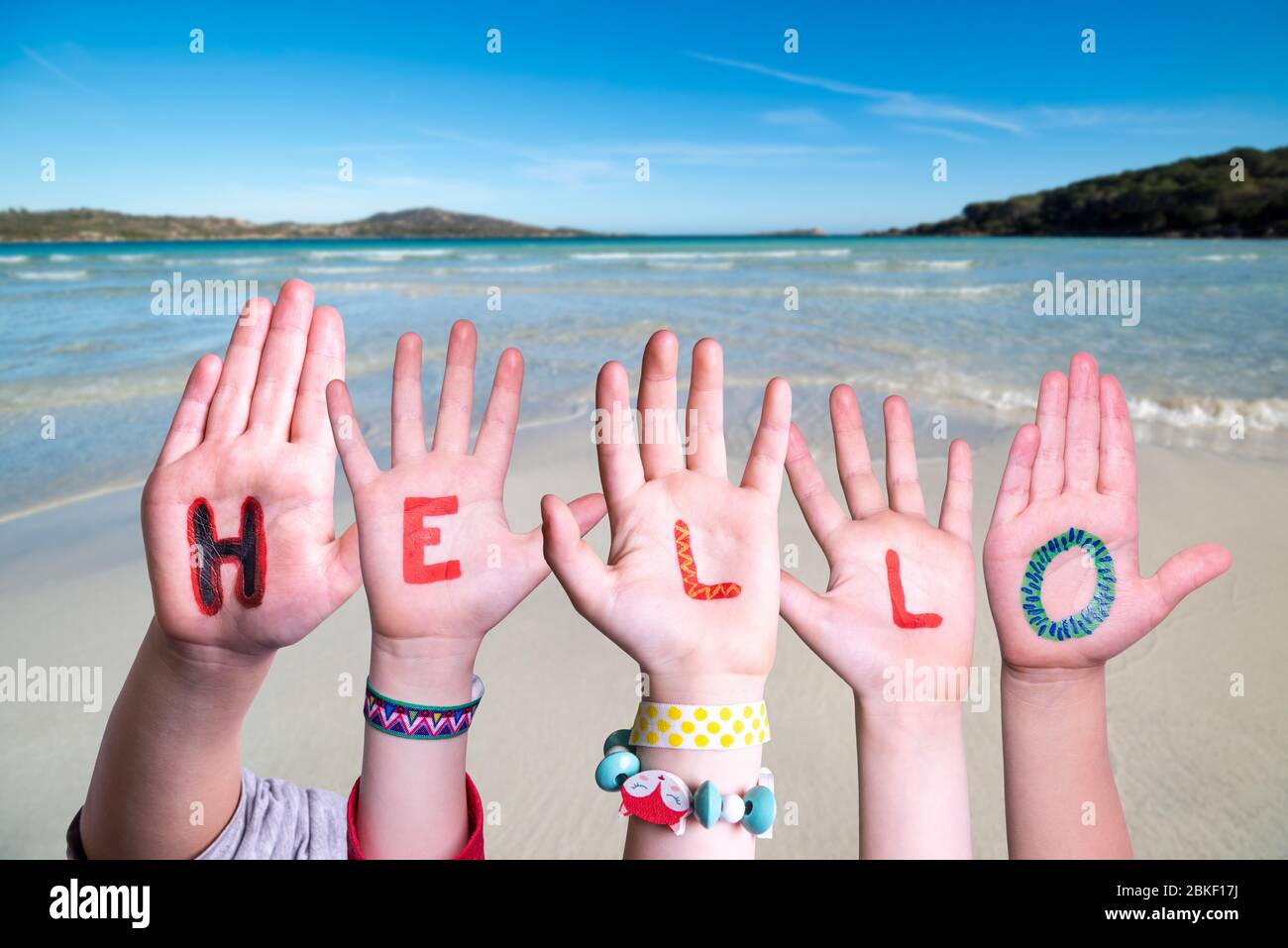 Children Hands Building Word Hello, Ocean Background Stock Photo - Alamy