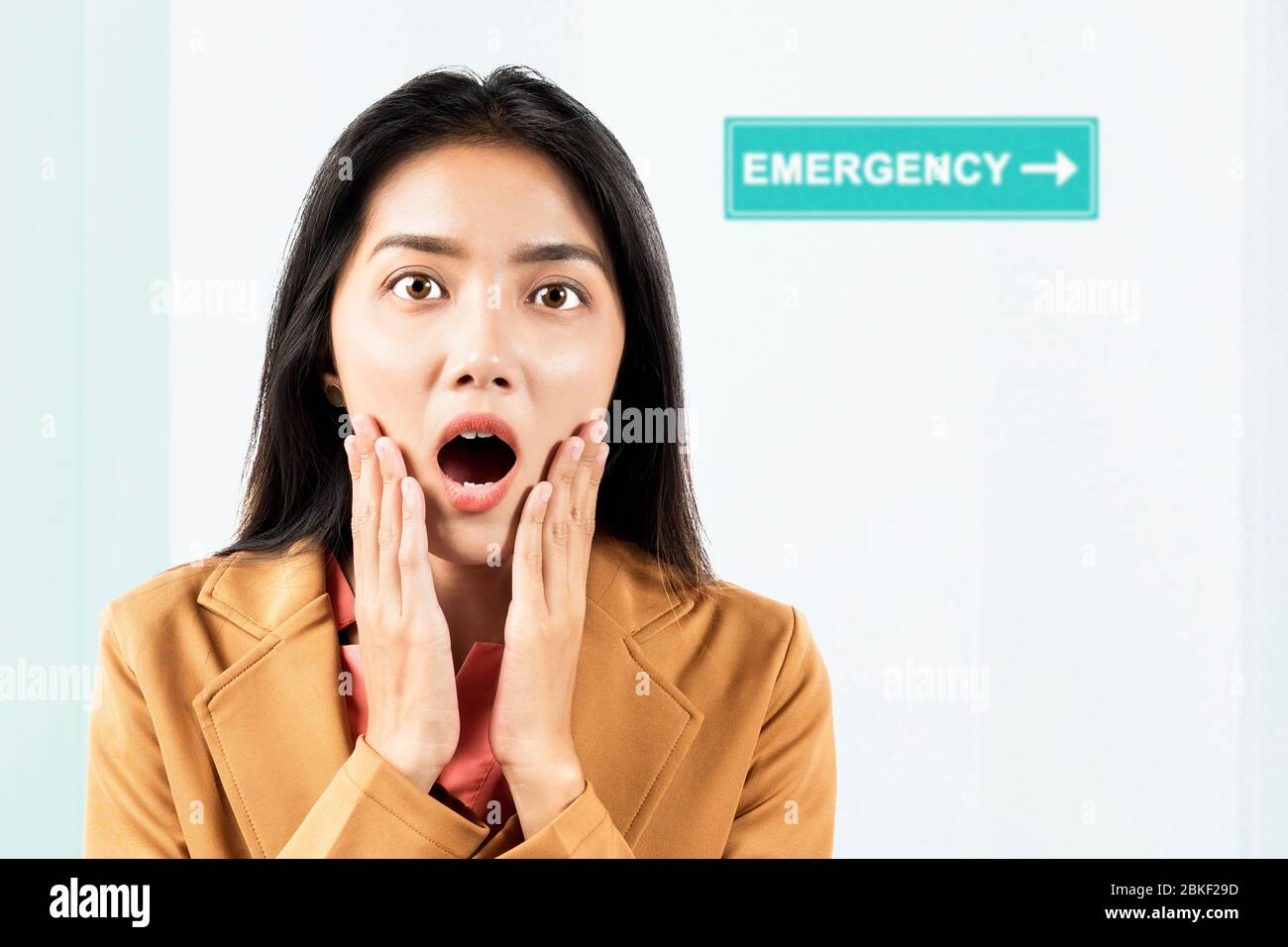 Asian businesswoman shocked in front of the emergency room in the ...