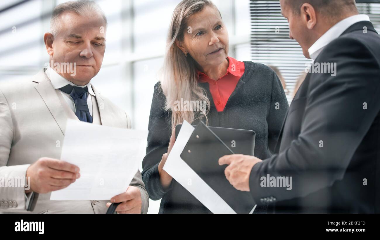 Business people discuss documents hi-res stock photography and images ...
