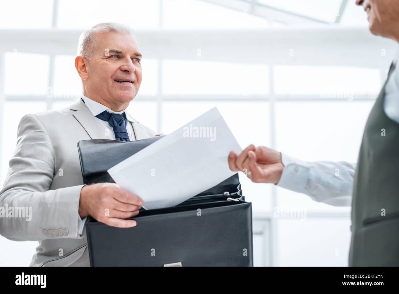close up. businessman receiving document from Bank employee Stock Photo ...