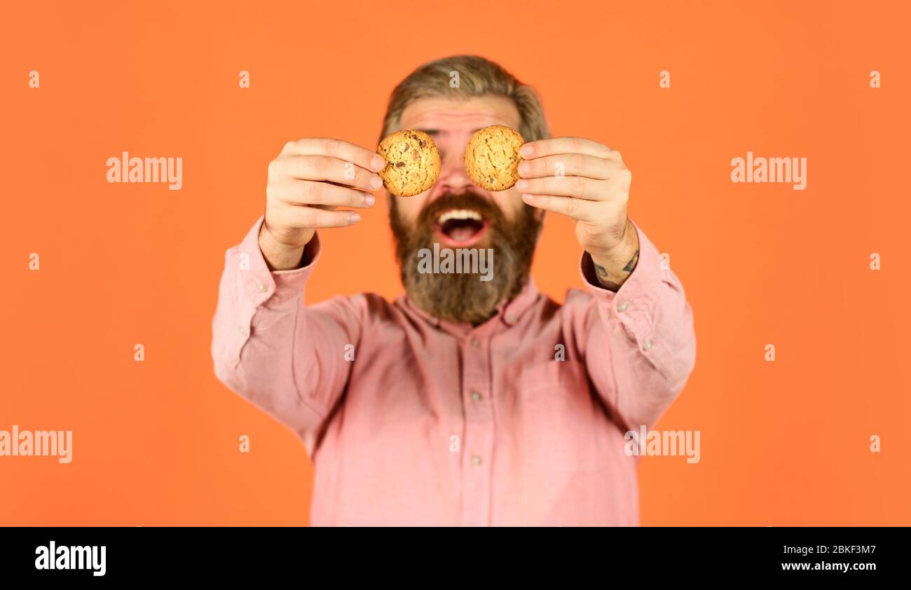 man eating chocolate chips cookie. full of calorie. concept of harmful ...