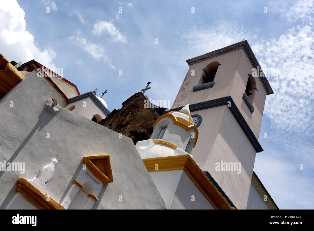 The white stucco facade and bell tower of Iglesia de La Merced in the ...