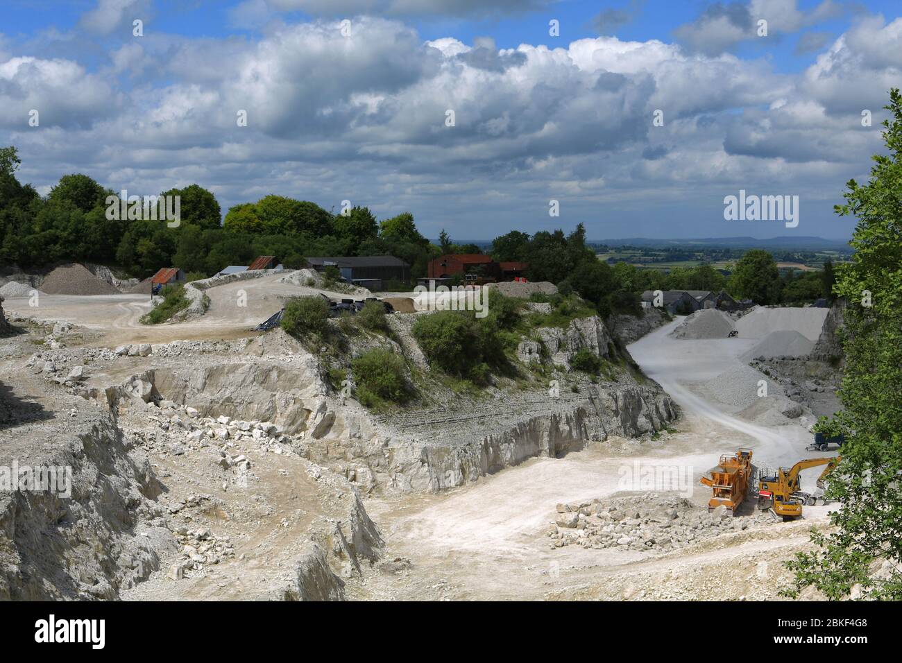 south downs overlooking a chalk pit quarry with puffy clouds on a ...