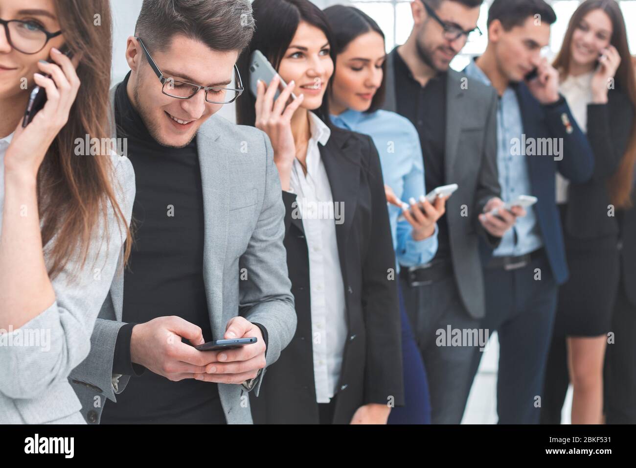 group of diverse young people use their smartphones Stock Photo - Alamy