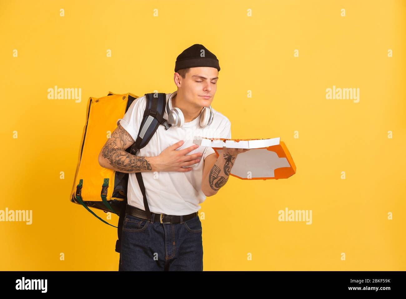 Holding pizza, smells good. Emotions of caucasian deliveryman isolated ...
