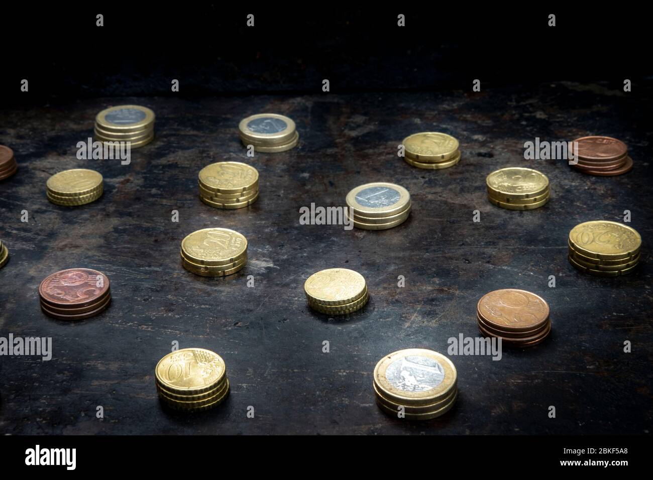 mosaic with a regular pattern made up of euro coins on a dark black ...