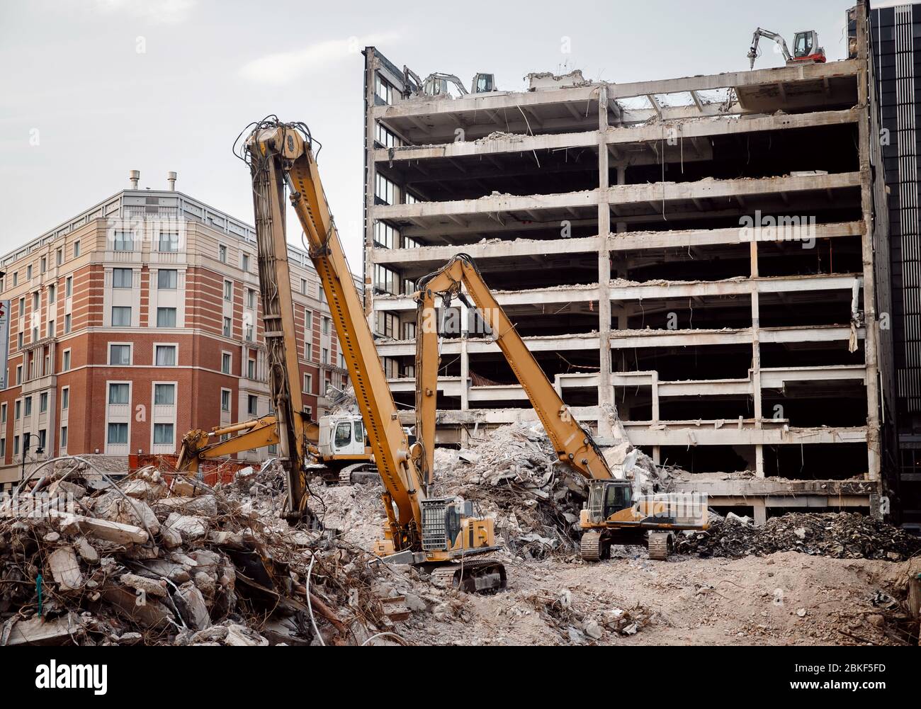 Dismantling the destroyed concrete house rubble with the help of ...