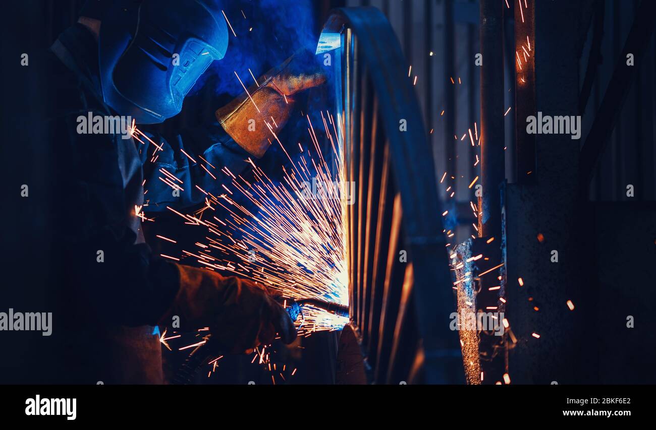 Professional welder performs welding hi-res stock photography and ...