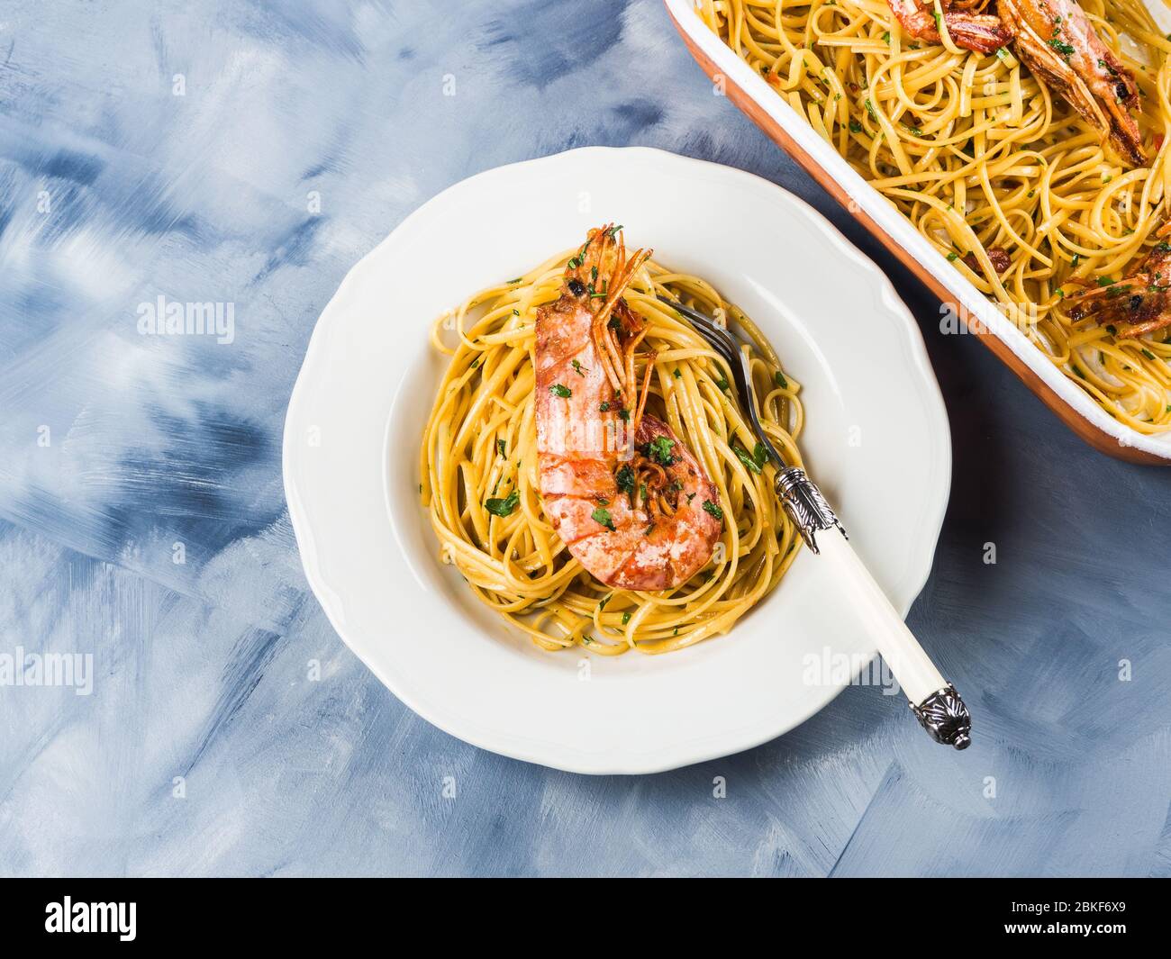 Linguine pasta with tiger prawn sauce in white dish Stock Photo - Alamy