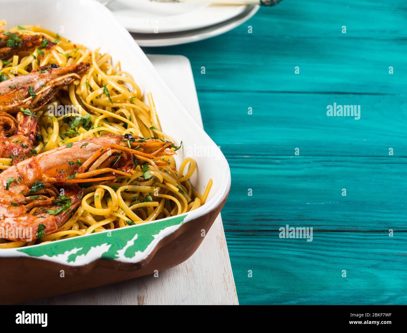 Linguine pasta with tiger prawn sauce in white dish Stock Photo - Alamy