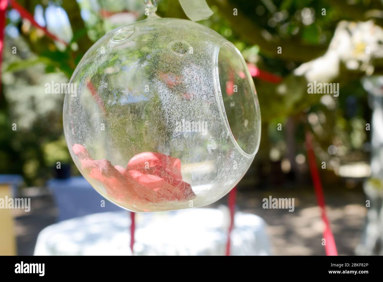 Dirt in a glass hanging pot outdoors at an event Stock Photo - Alamy