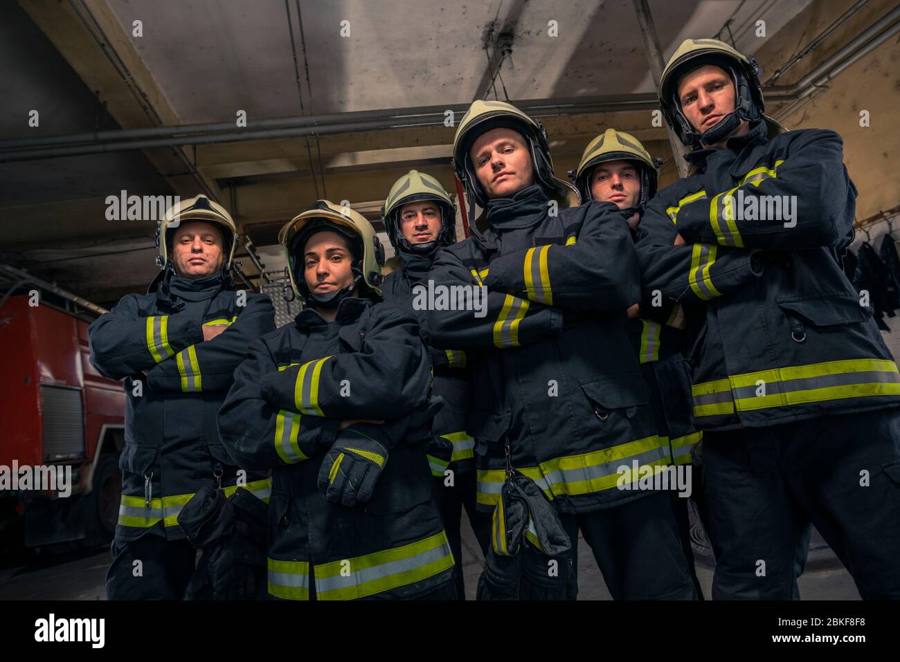 Group of firefighters standing confident with arms crossed. Firemen ...
