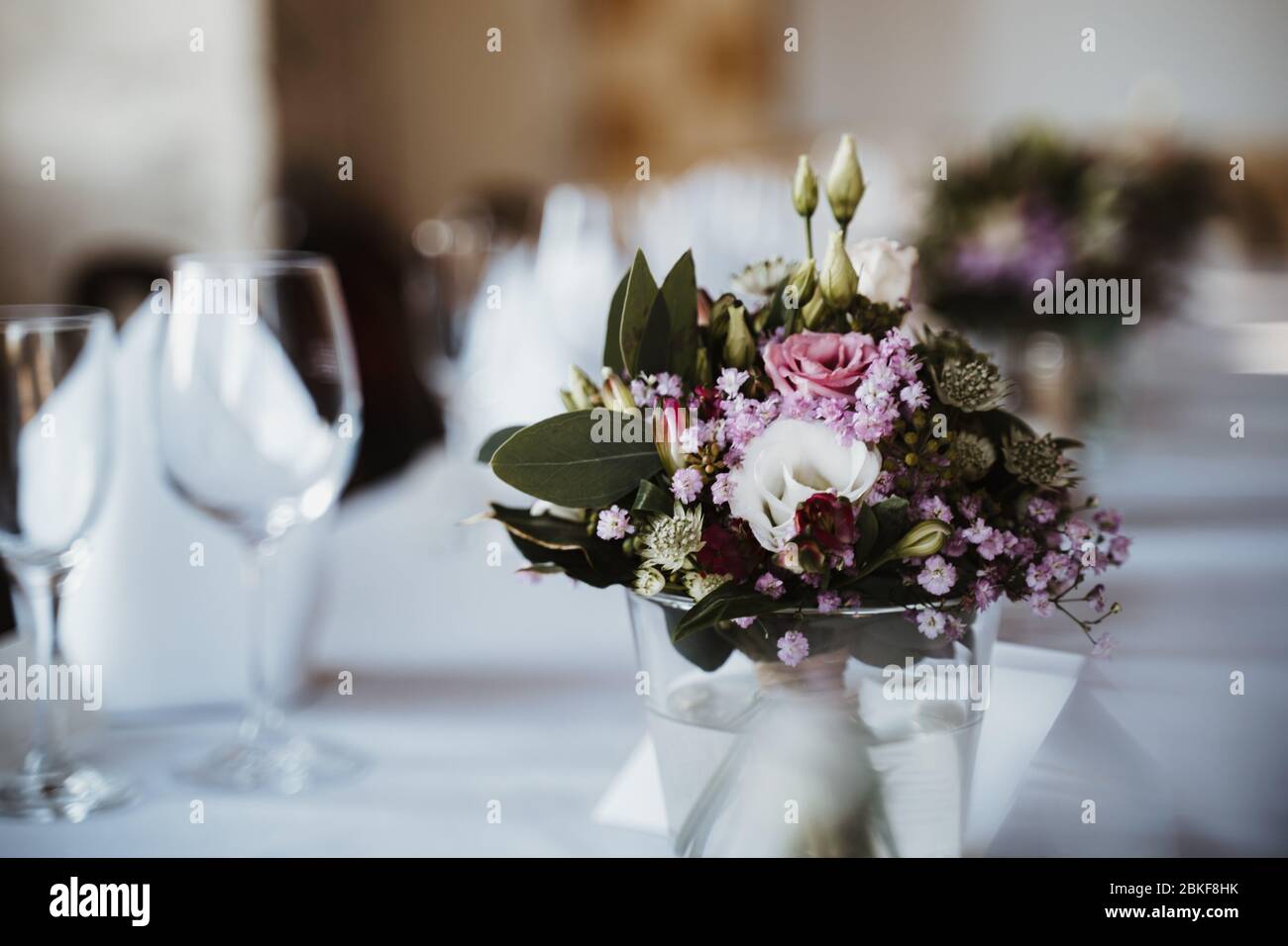 photo of flowers on a table in a vase with plates Stock Photo - Alamy