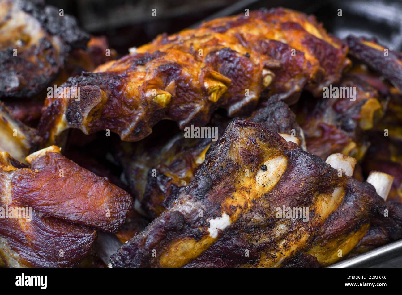 Marinated pork spare ribs, stack or pile of fresh grilled meat during ...