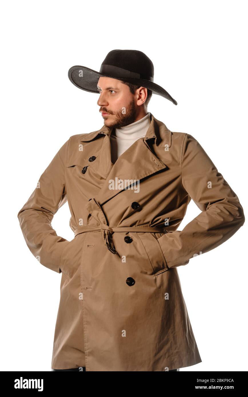 Body shot of an attractive male model dressed in modern long coat on ...