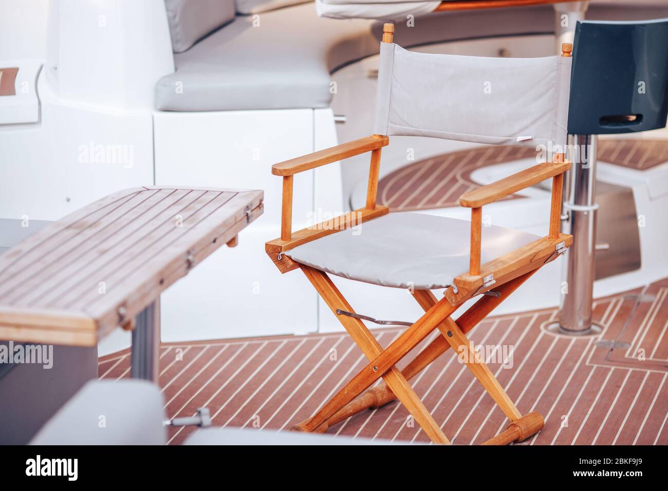Folding chair made of wood stands on deck ship or yacht Stock Photo - Alamy