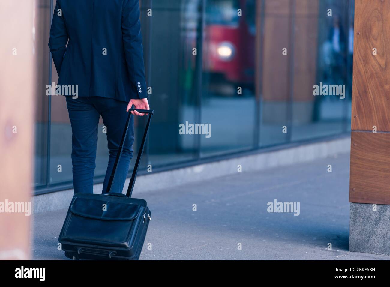 Close up photo a formal businessman dragging his suitcase, manbag, pull ...