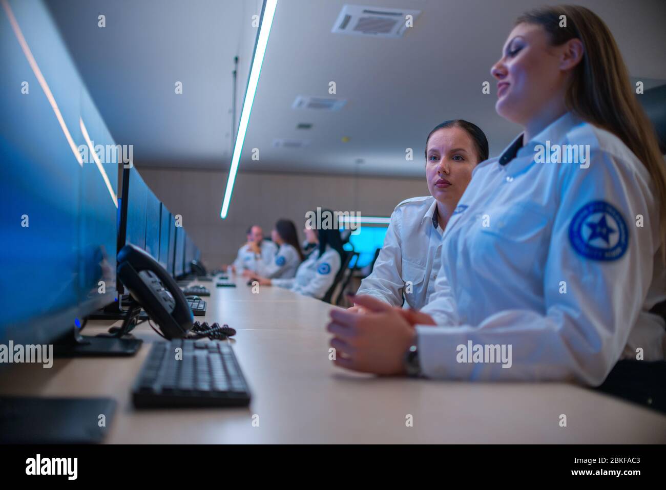 Close up photo of a security female agent monitoring the CCTV in a main ...