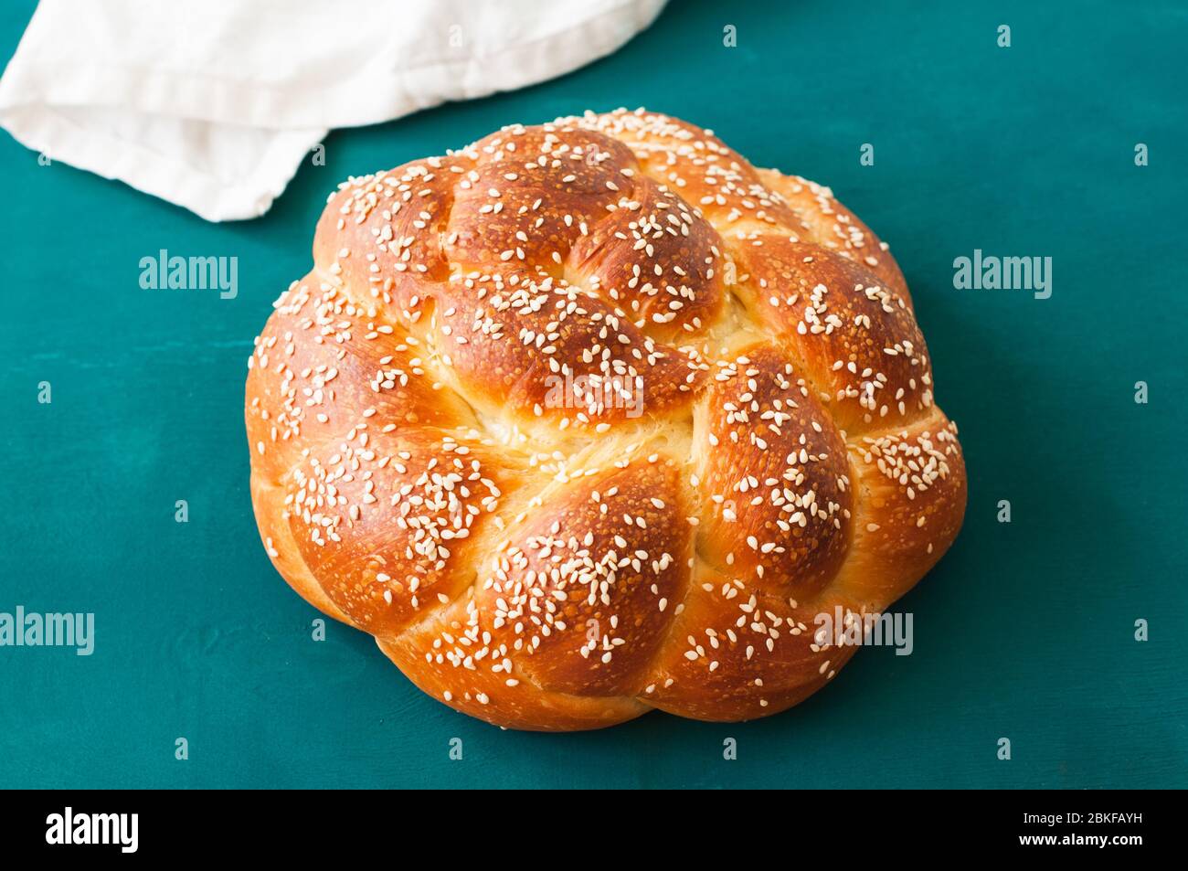 Homemade round challah with sesame seeds. Traditional freshly baked ...