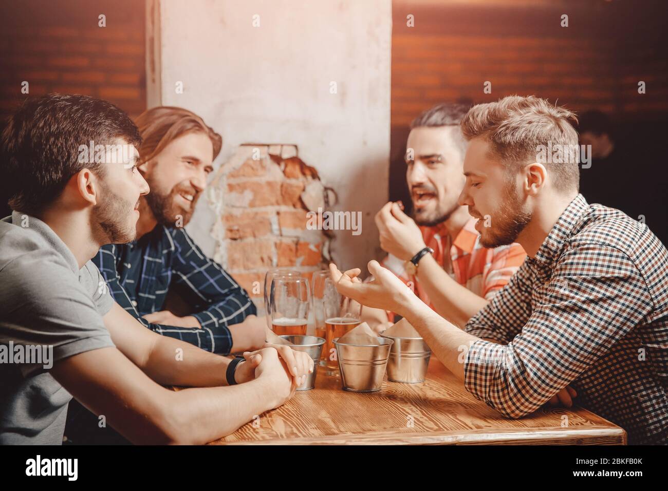 It warm friendly atmosphere. Company of friends men relax in bar ...