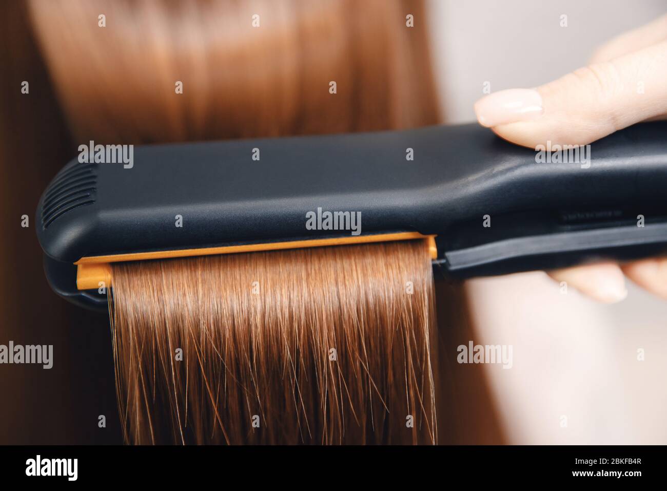 Hair straightening. Professional hairstyle and care in spa beauty salon ...