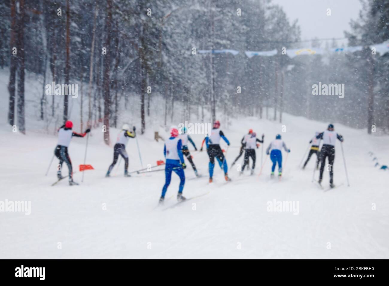 Men run skiing start. Blurred background frame. Winter day, snowing ...