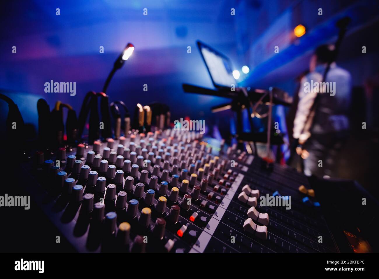 Sound equipment close-up, dancing in nightclub. background is man in ...