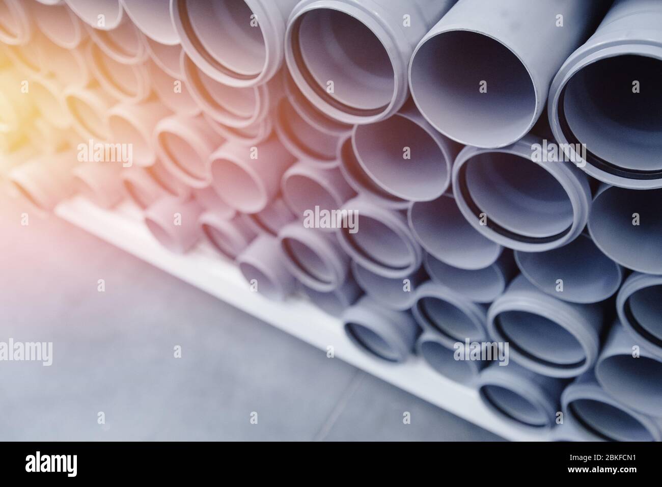 PVC plastic construction pipes for water are displayed in row on ...