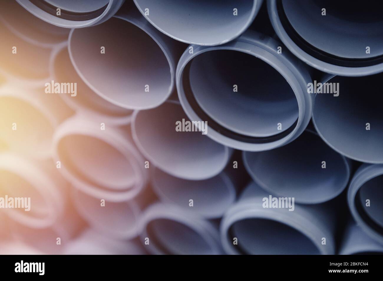 PVC plastic construction pipes for water are displayed in row on ...