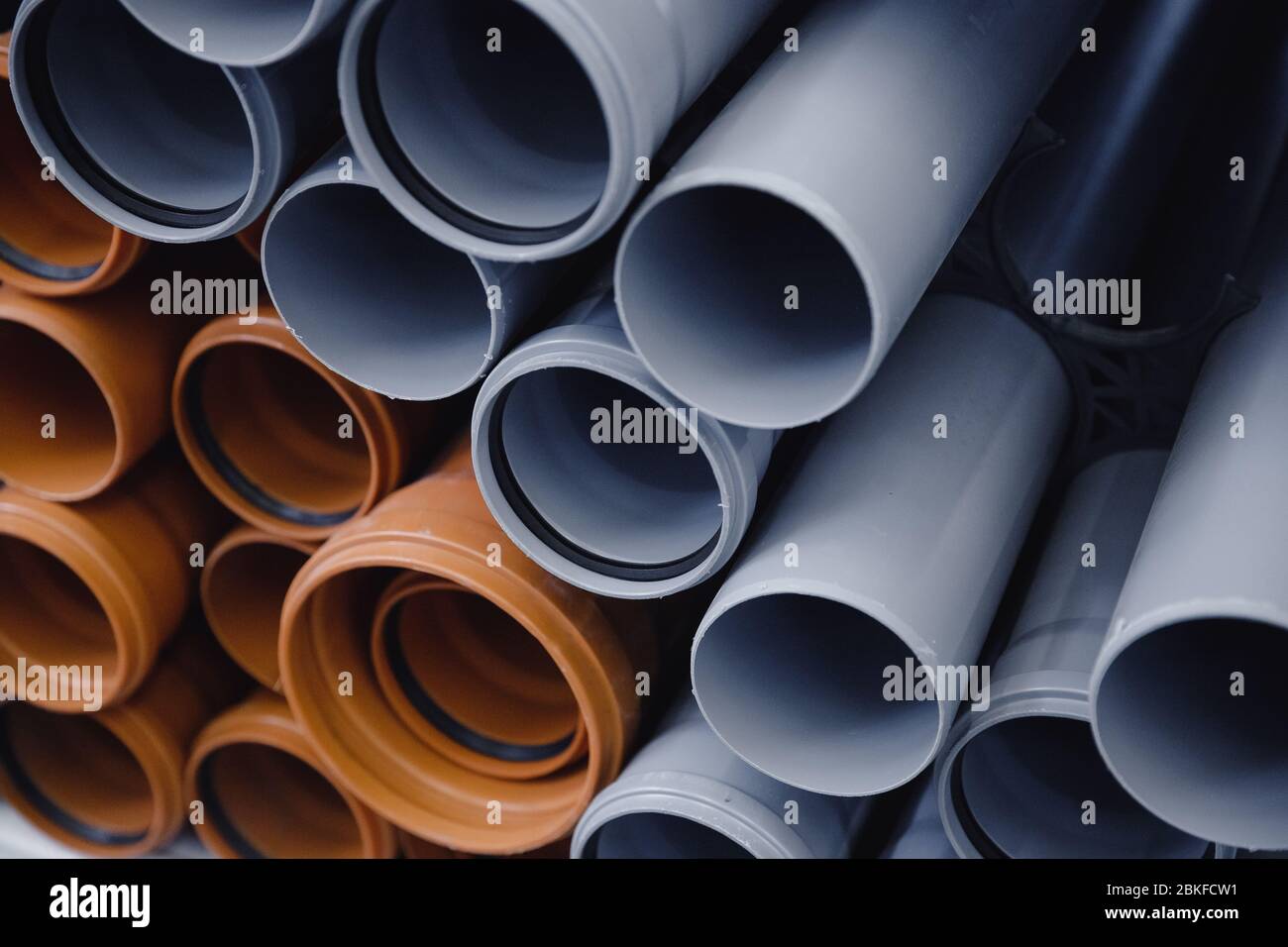 PVC plastic construction pipes for water are displayed in row on ...