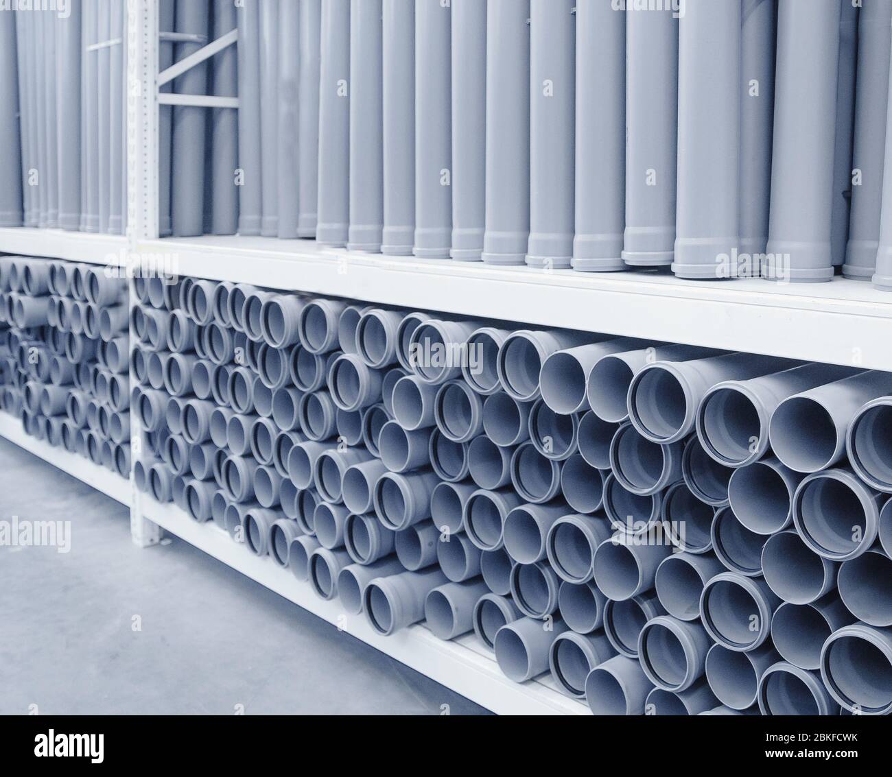 PVC plastic construction pipes for water are displayed in row on ...