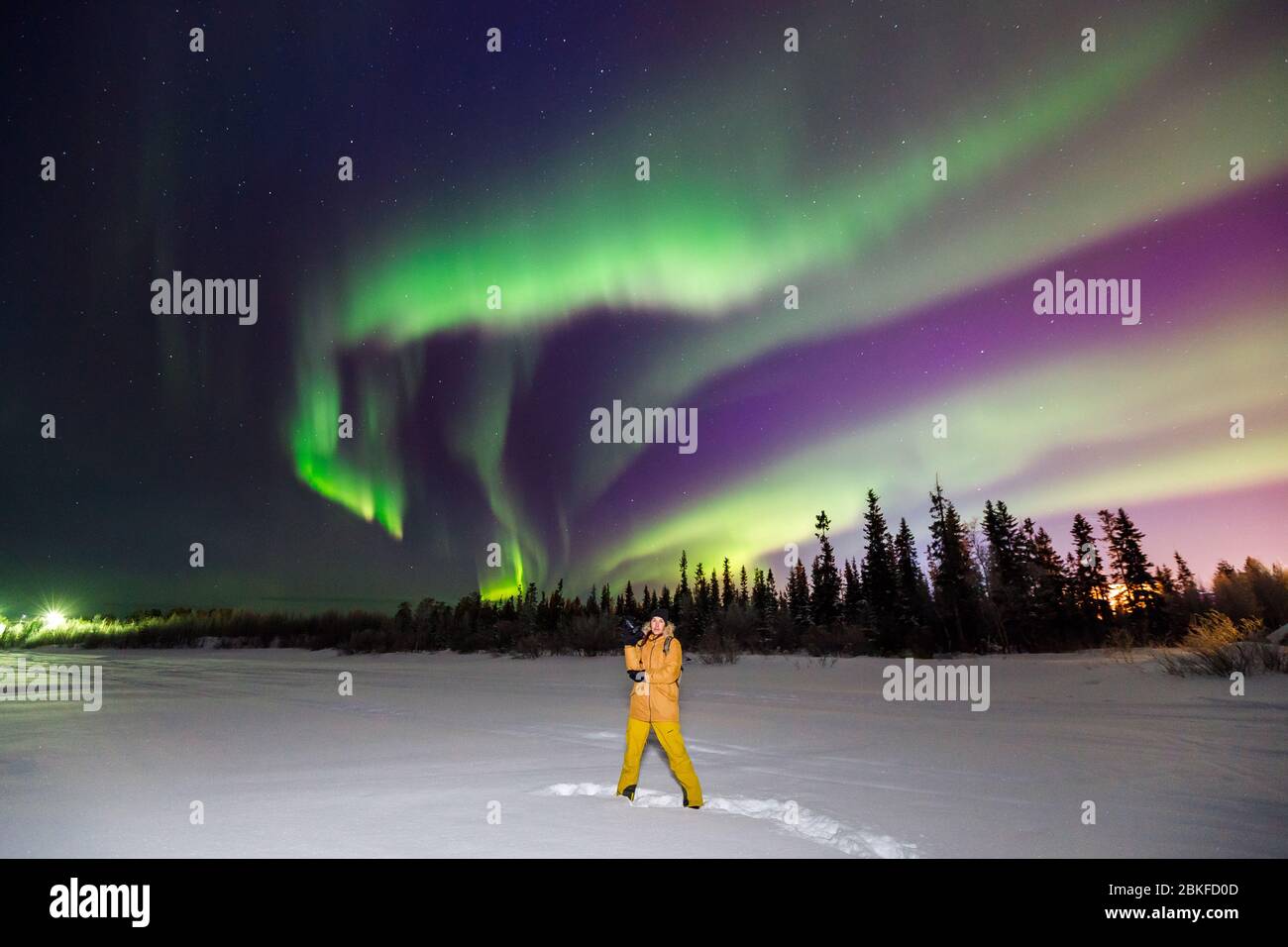 Man Traveler in yellow jacket with camera on background of northern ...