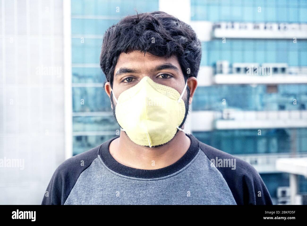 Indian man in yellow protective mask Stock Photo - Alamy