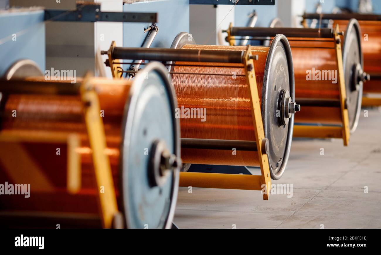 Production of copper wire, bronze cable in reels at factory Stock Photo ...