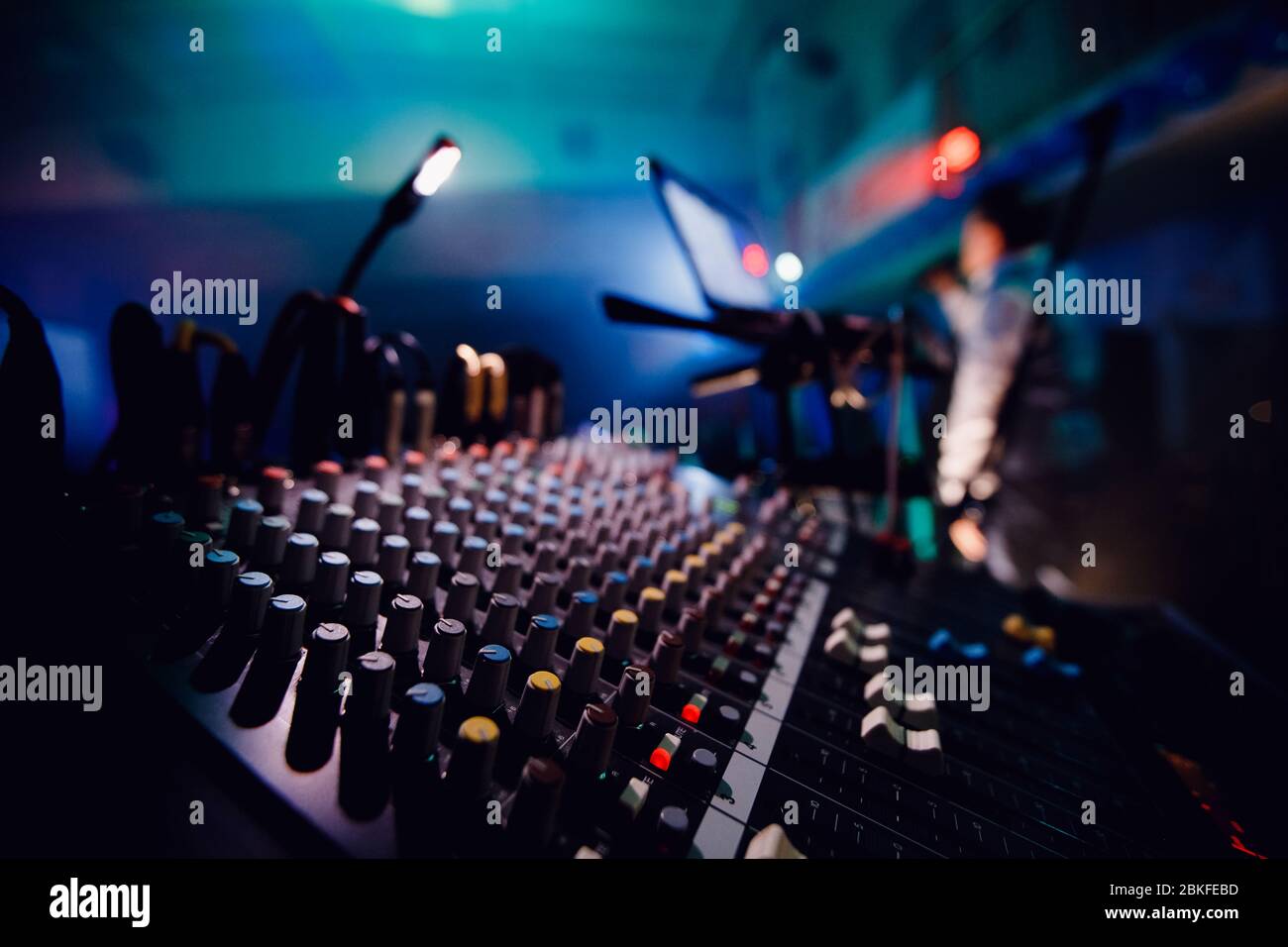 Sound equipment DJ console. Background blurred. Blue and purple colors ...