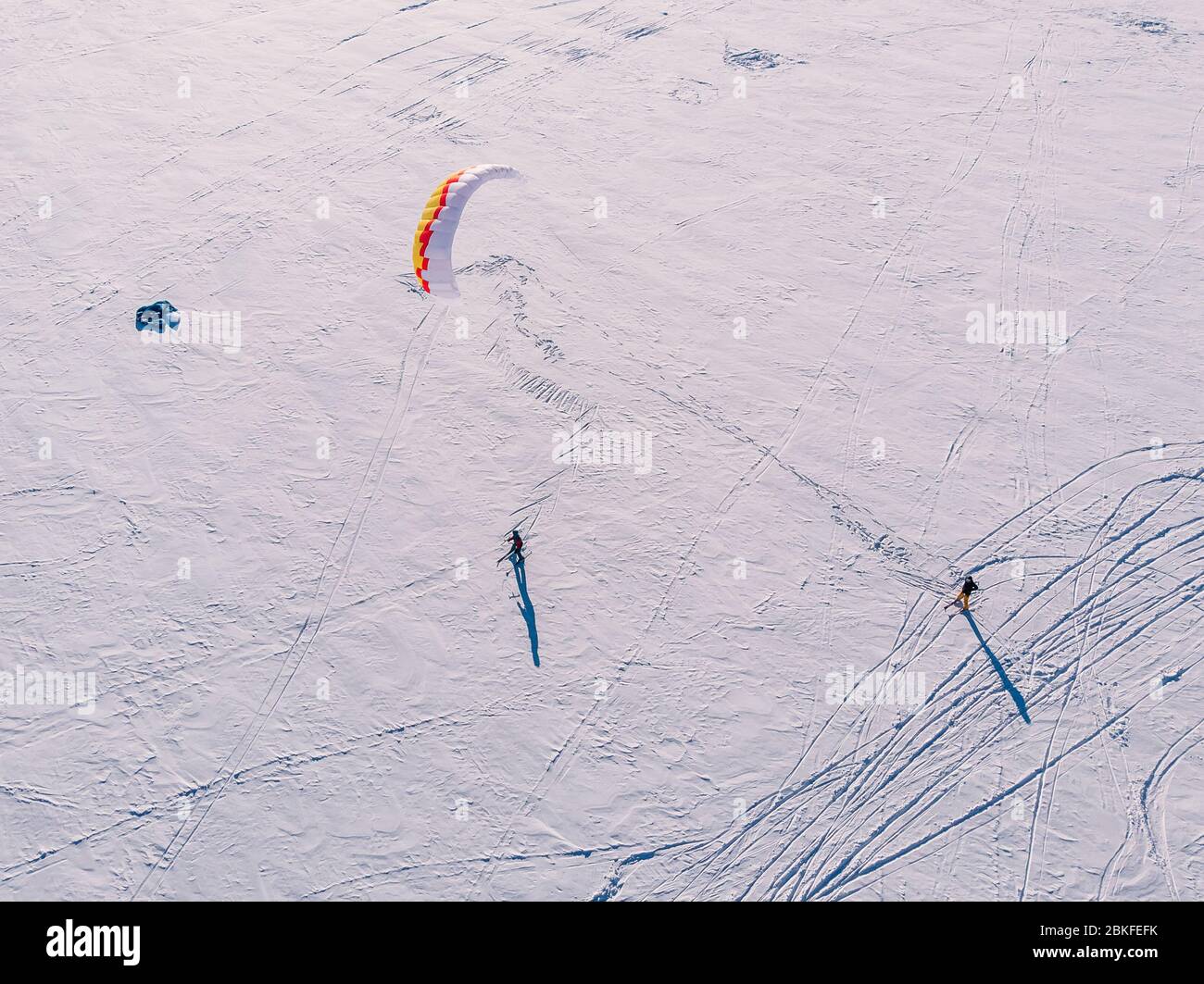 Male athlete on mountain skiing with dreams kite free ride on frozen ...